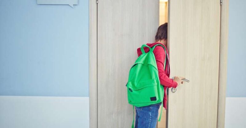 student opening door